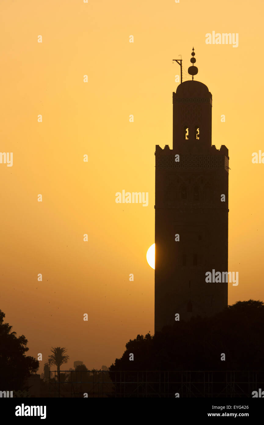 Morocco, Sun setting behind minaret of Koutoubia mosque; Marrakesh ...