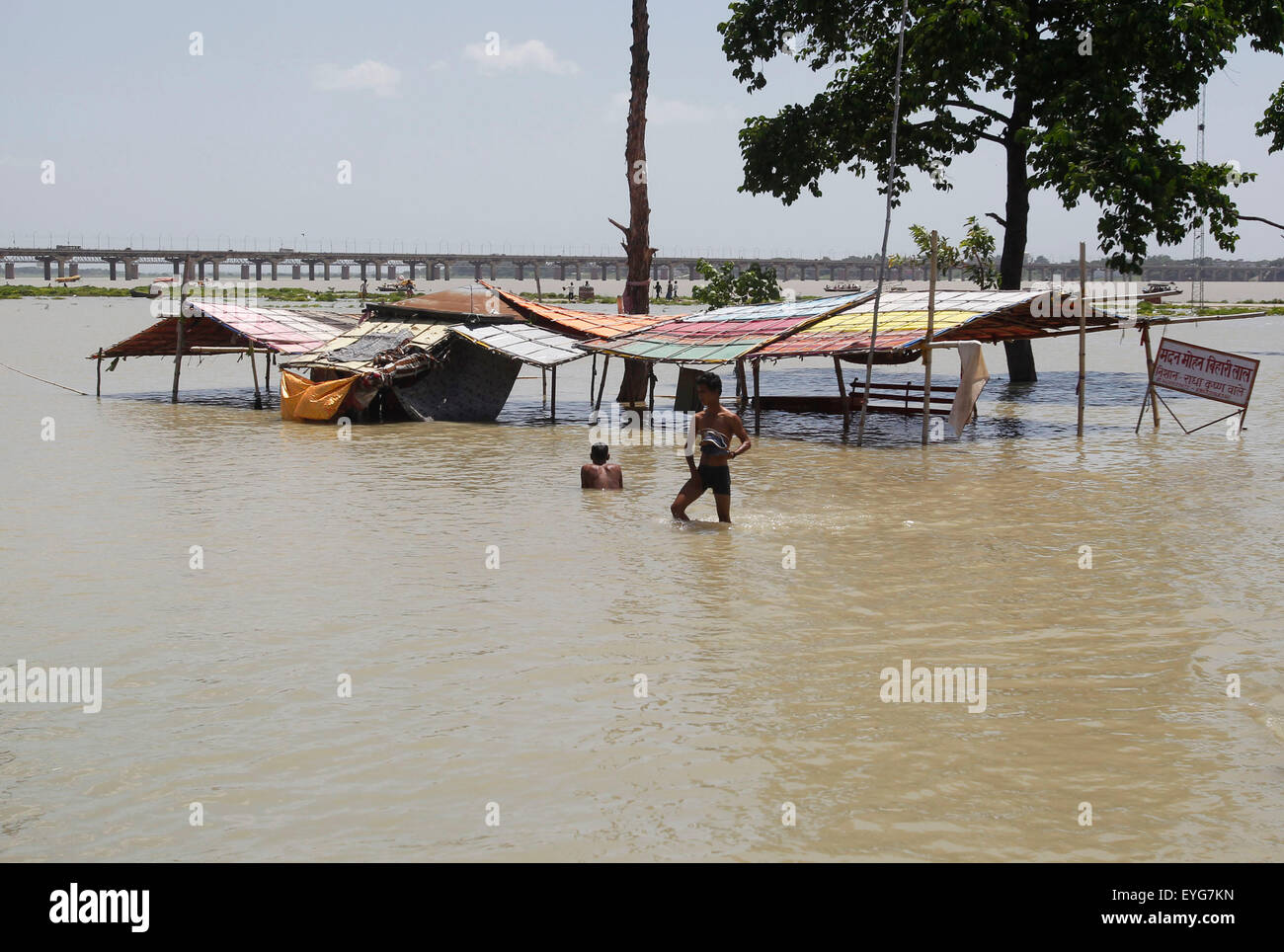 Allahabad, India. 29th July, 2015. Hindu devotees walk from flooded ...