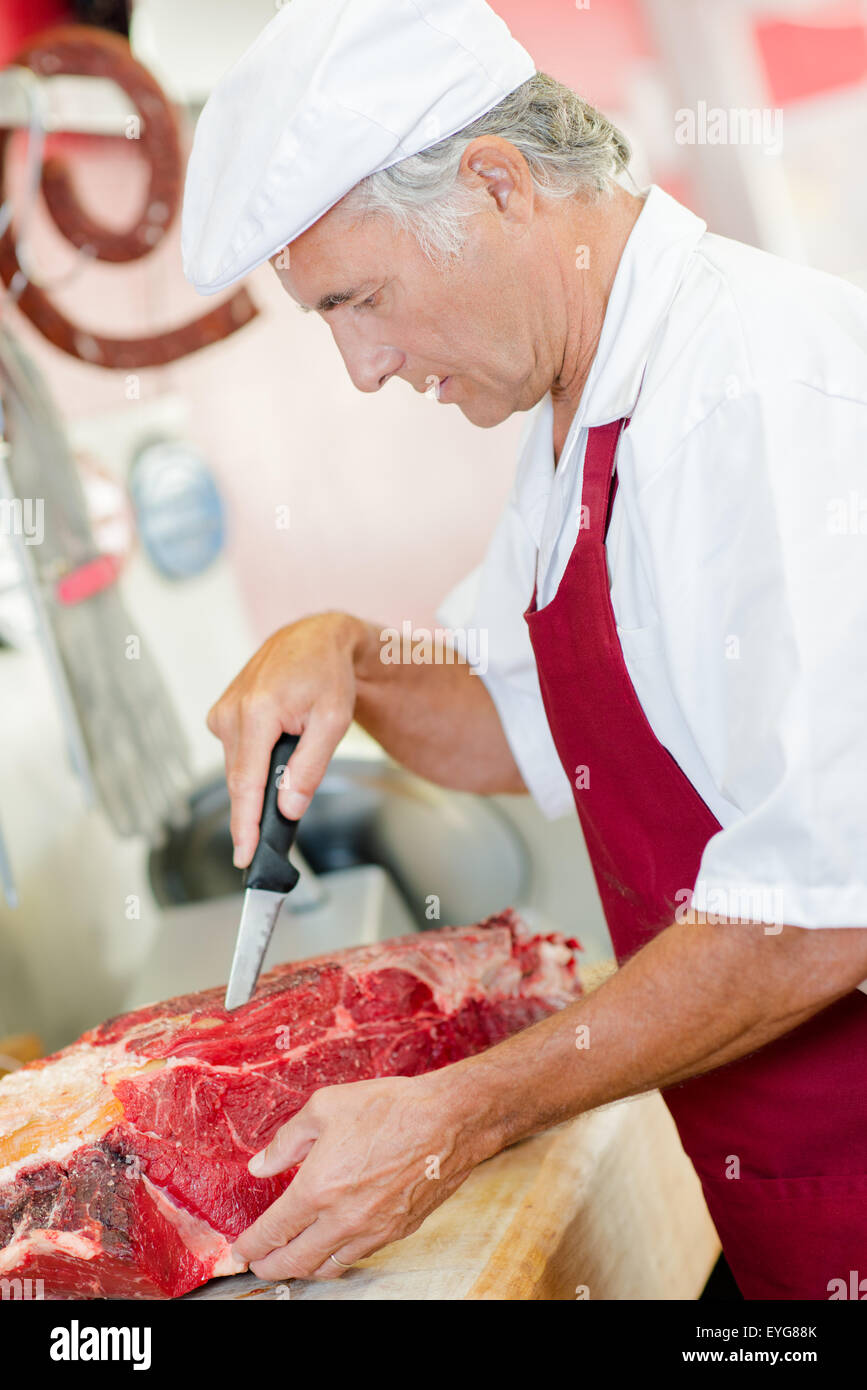 Butcher cutting up meat Stock Photo - Alamy