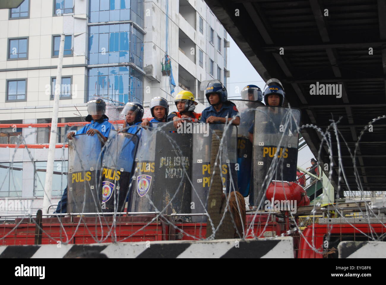 Manila, Philippines. 27th July, 2015. Riot police stand on-watch atop a ...