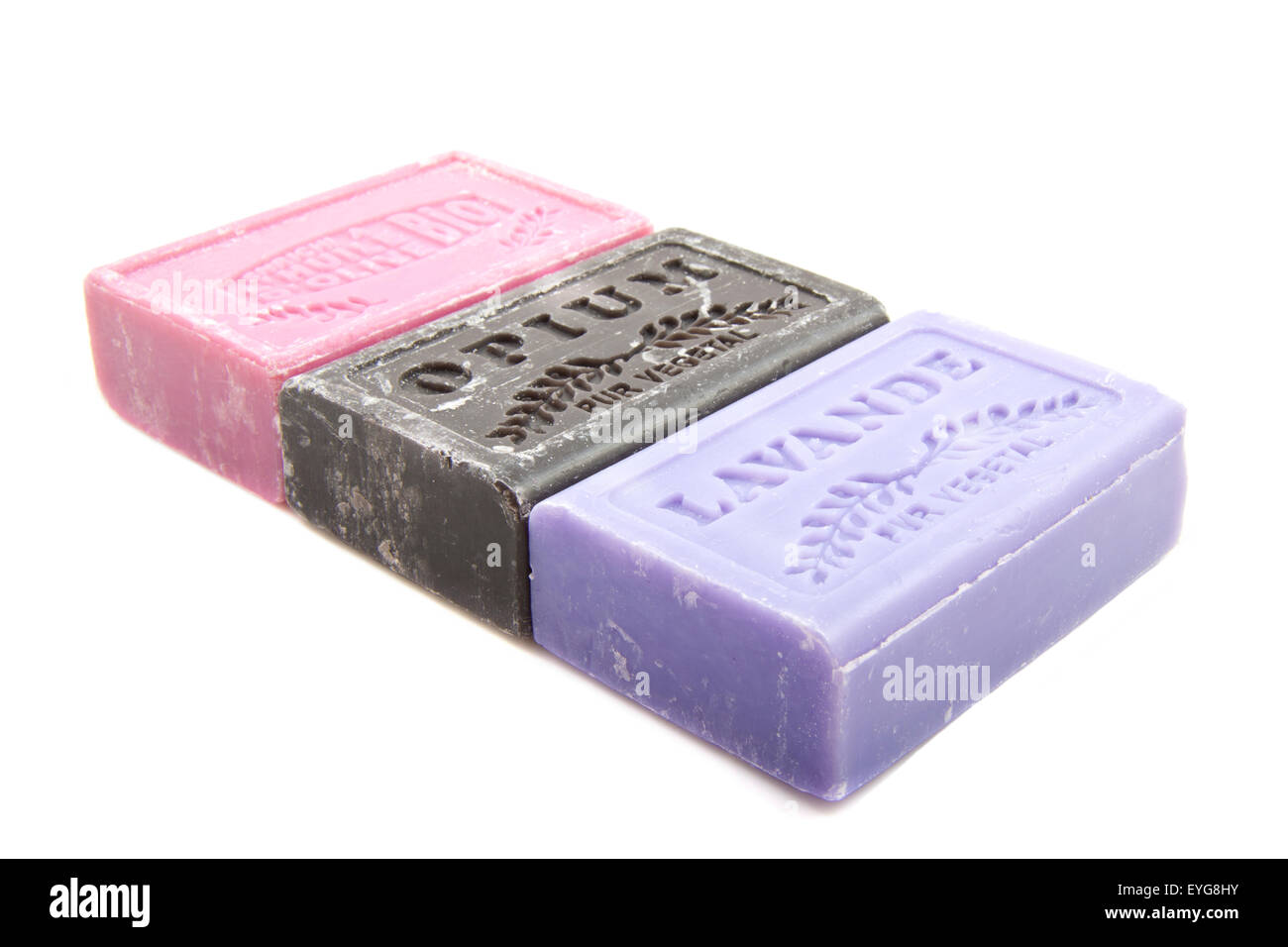 Three colorful pieces of handmade soap in a row over white Stock Photo ...