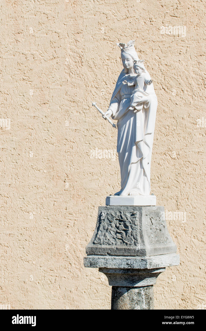 saint mary and Jesus marble Statue on an old column outside a church of ...