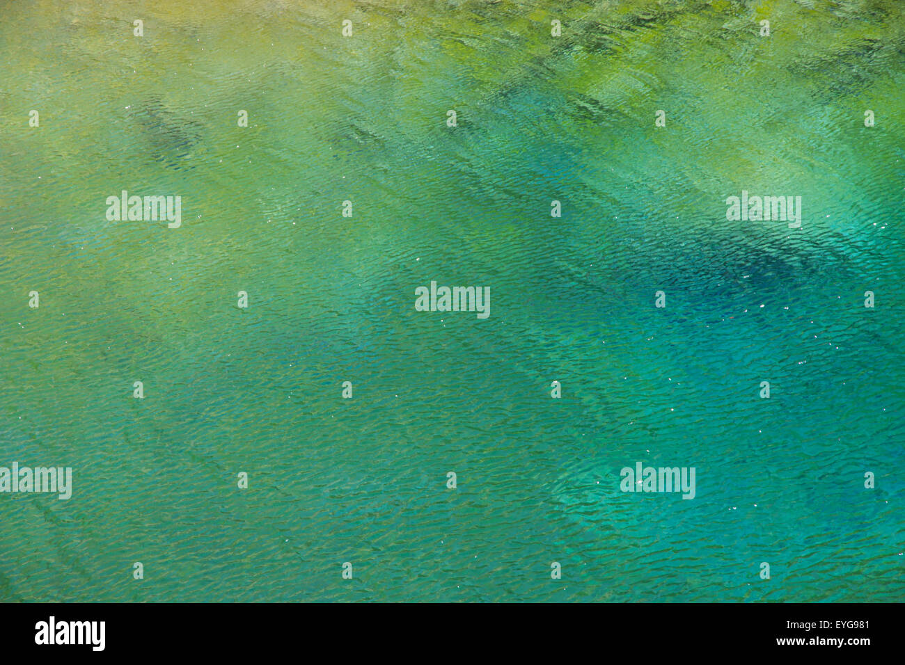 mountain lake has a colorful glittering texture created by turquoise ...