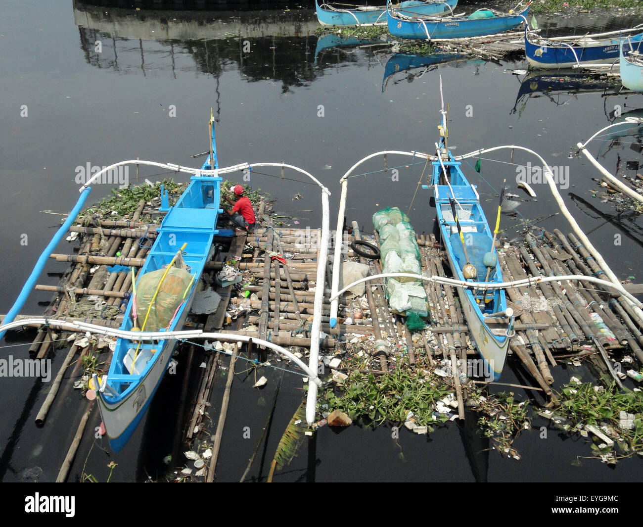 Navotas City, Philippines. 29th July, 2015. A Filipino paints a boat ...