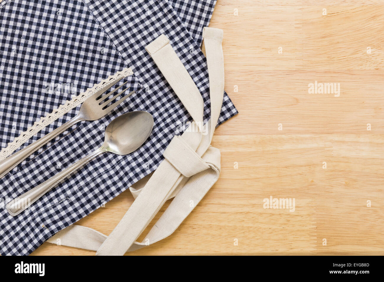 Spoon and Fork put together on table background Stock Photo - Alamy
