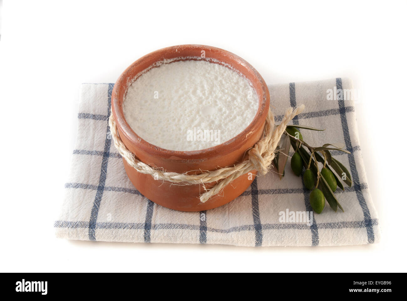 Traditional Greek yogurt in a brown ceramic pot isolated on white ...