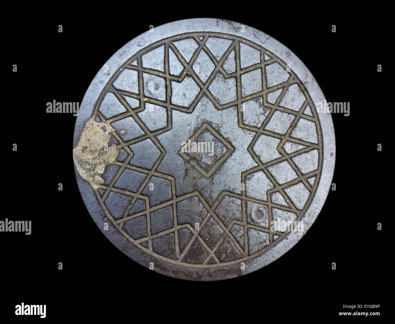 A single cast iron coal whole hatch against a black background Stock ...