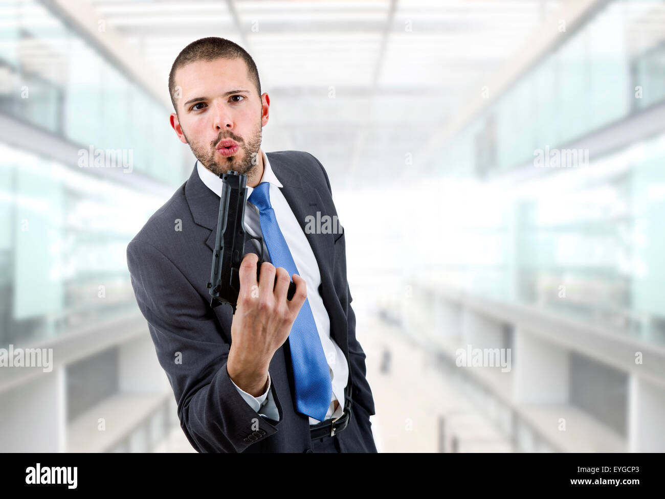 young businessman with a gun, at the office Stock Photo - Alamy