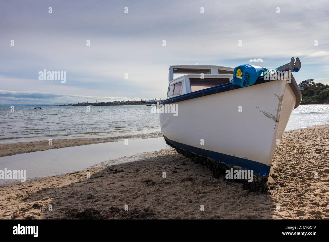 a fishing boat washed up on a beach from a recent storm in Melbourne ...