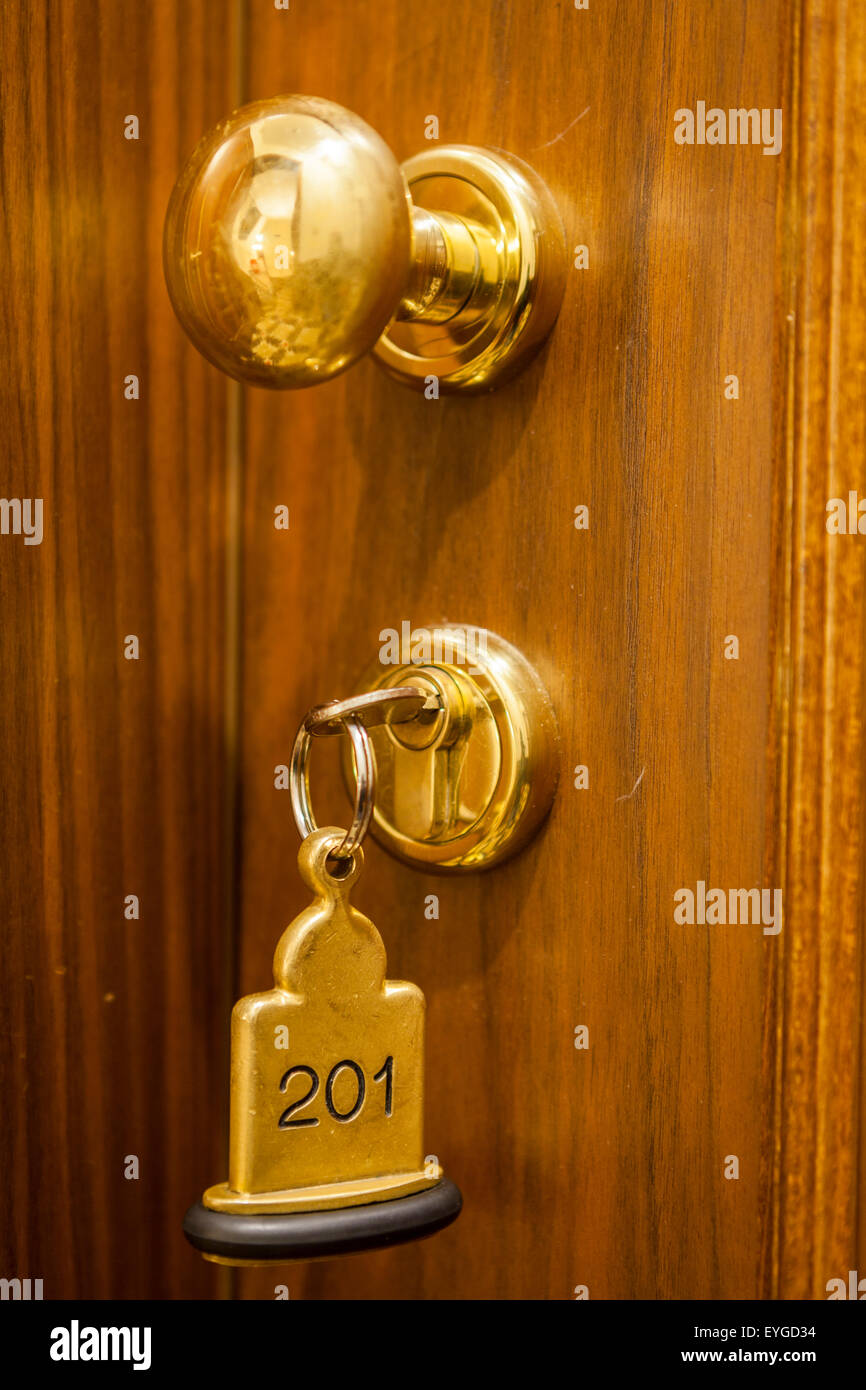 Hotel Room Key lying on Bed with keyring golden Stock Photo - Alamy