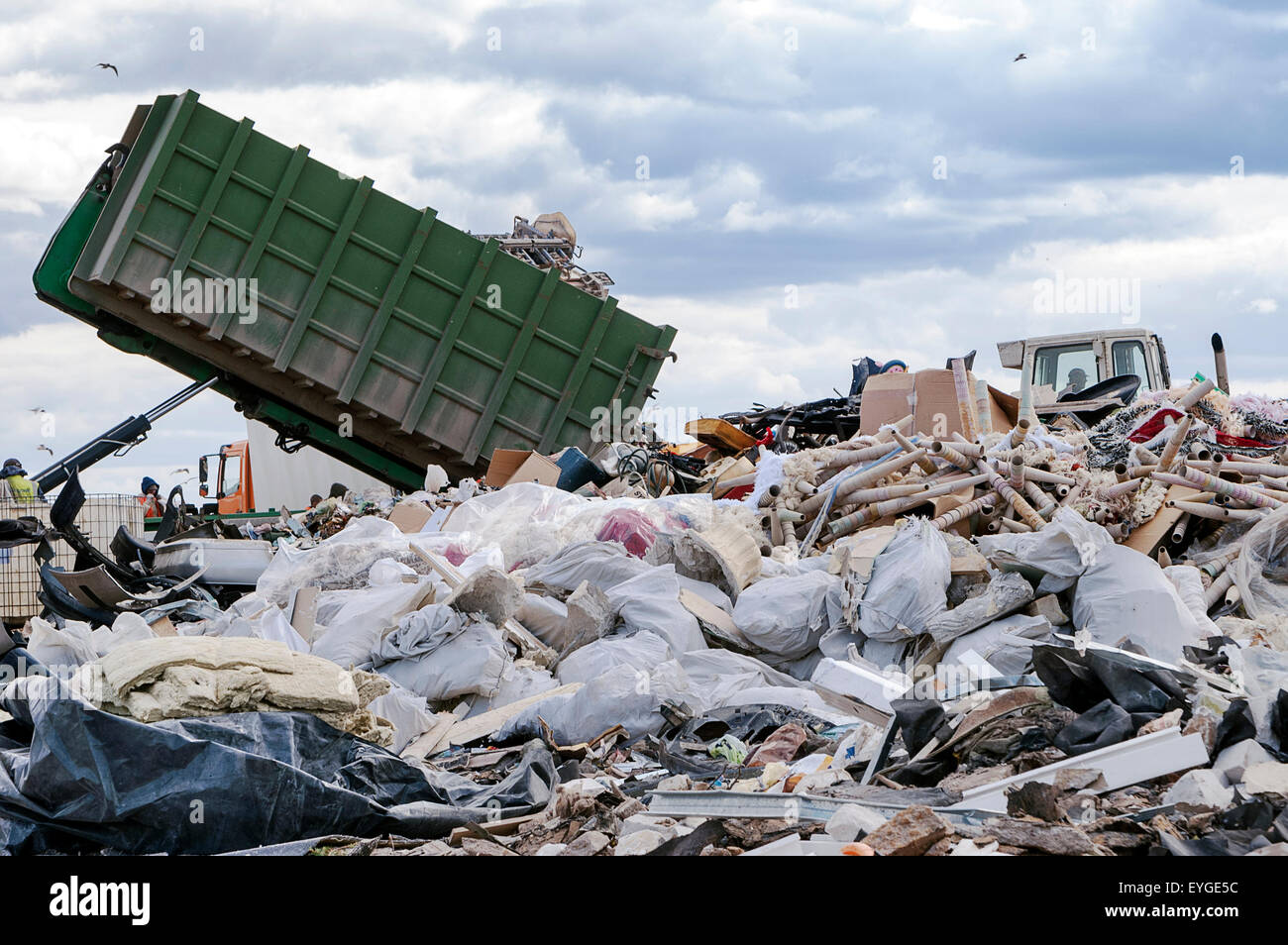 Garbage truck unloads garbage from container at the dump Stock Photo ...