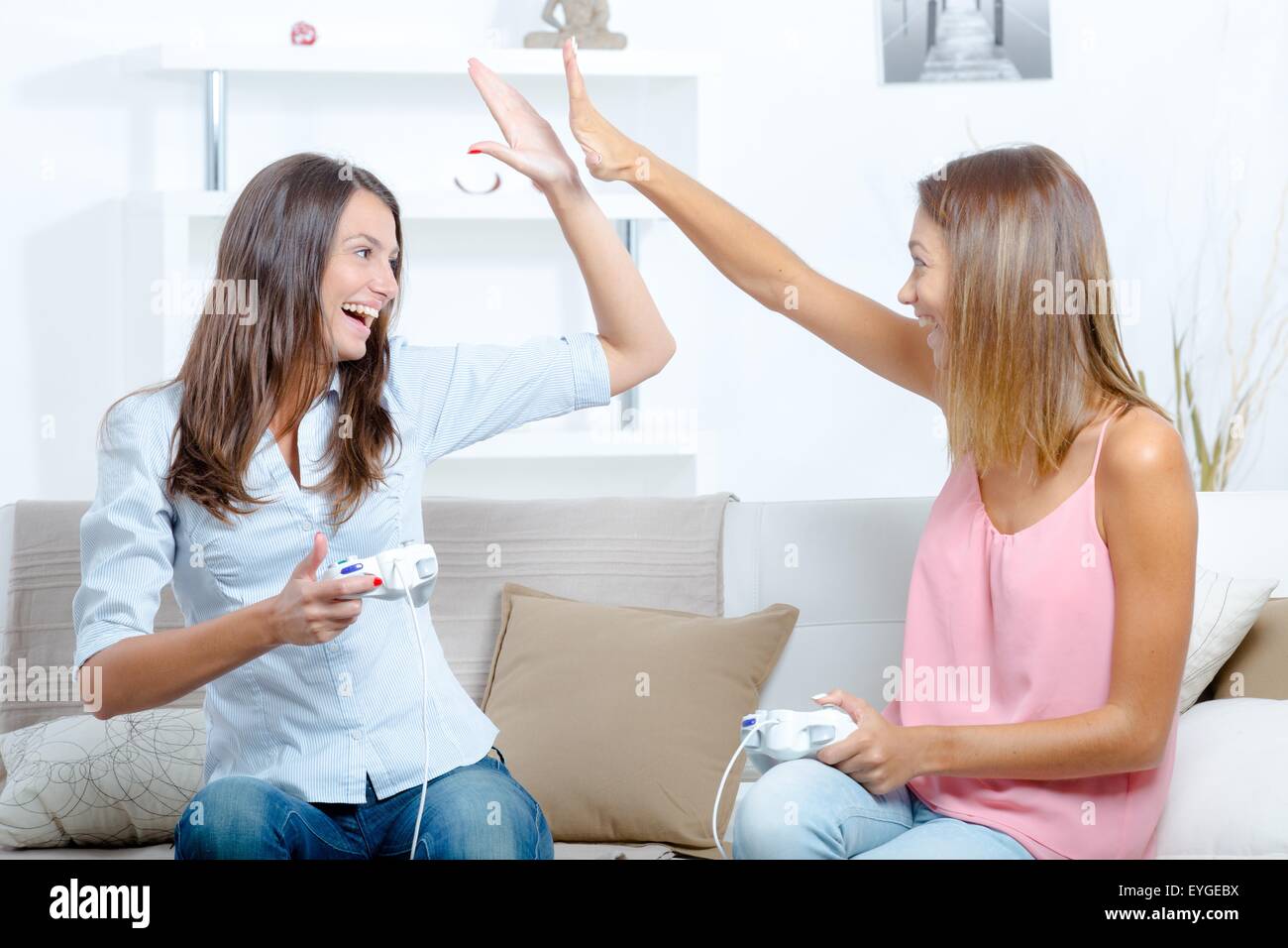 Two women having fun playing video games Stock Photo - Alamy