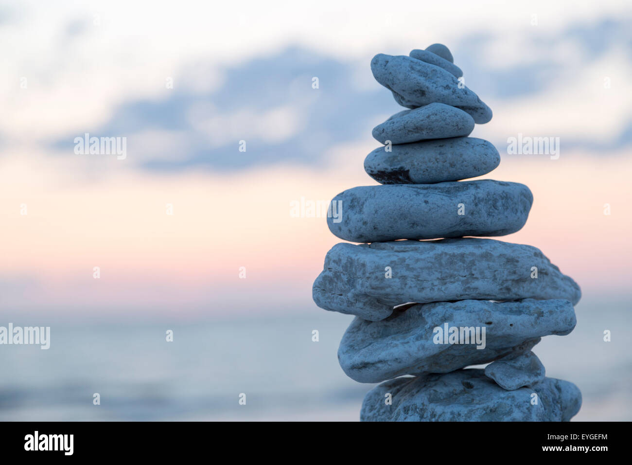 Rocks Piled on Each Other by ocean at sunset Stock Photo - Alamy