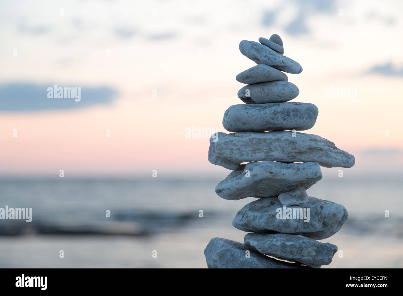 Rocks Piled on Each Other by ocean at sunset Stock Photo - Alamy