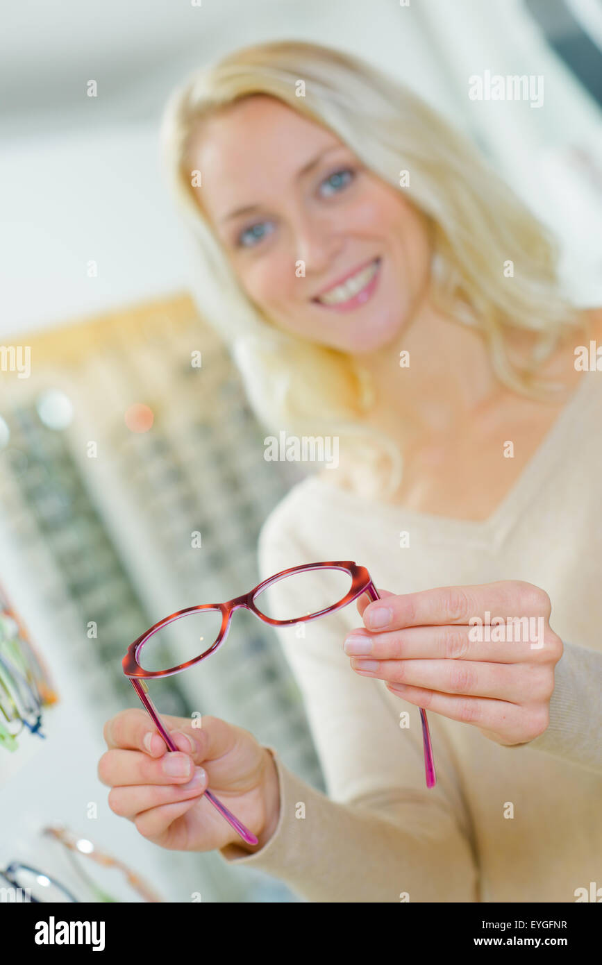 Woman holding spectacles Stock Photo - Alamy