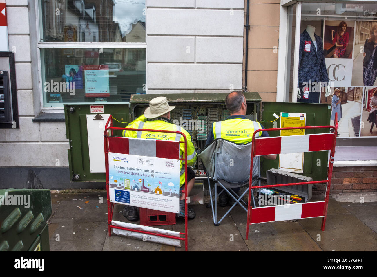 Two openreach telecom men working in a cab on street in bridgnorth ...