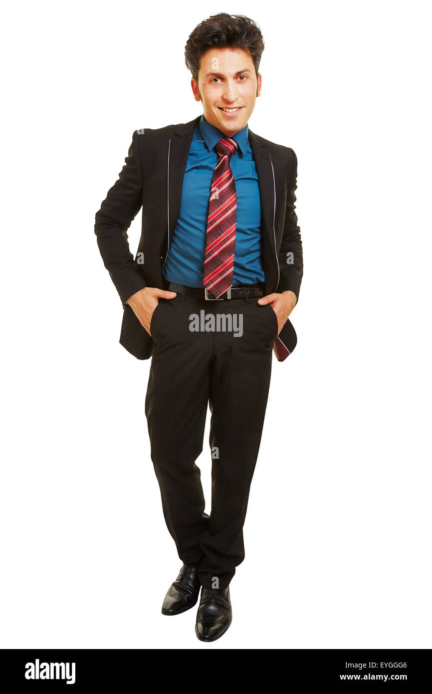 Young business man in apprenticeship standing frontal with hands in his ...