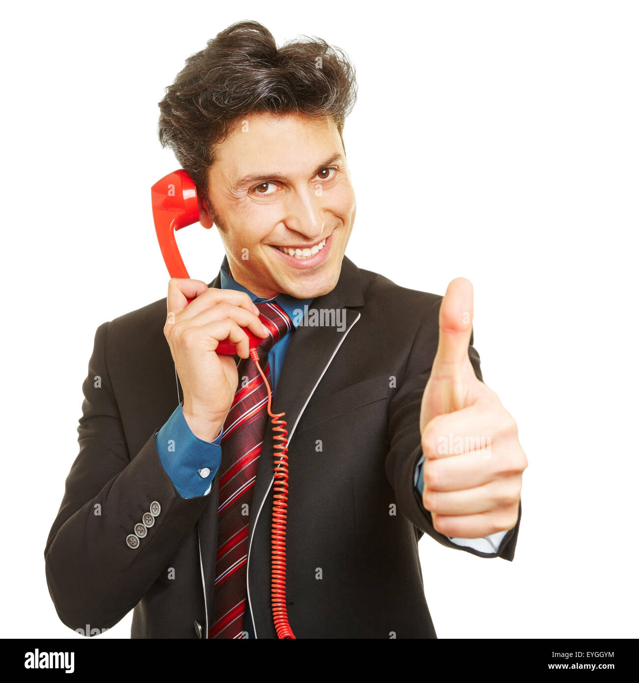 Happy business man holding thumbs up during a phone call with red ...