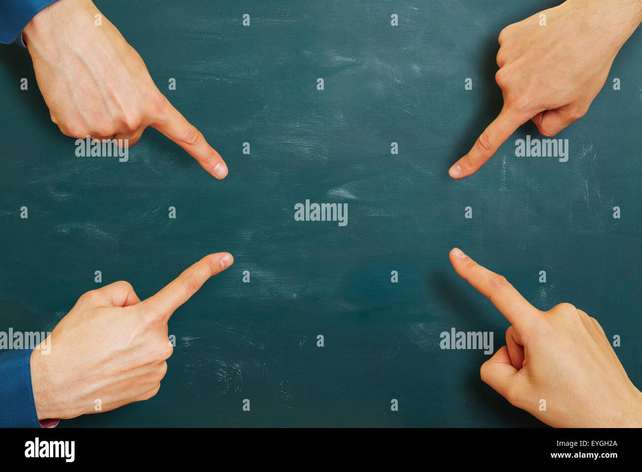 Many hands of business people pointing to green empty chalkboard Stock ...
