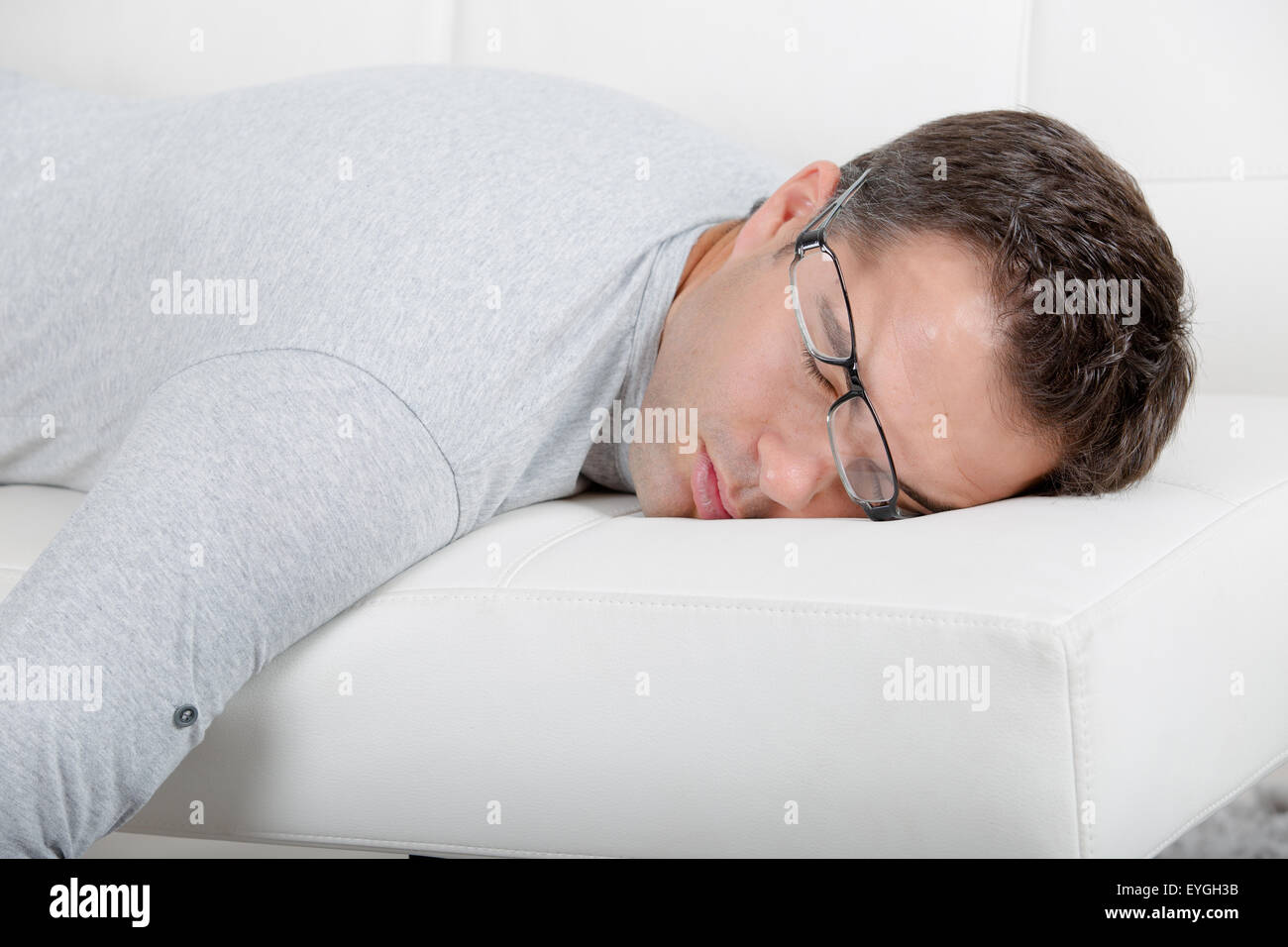 Man snoozing on the sofa Stock Photo - Alamy