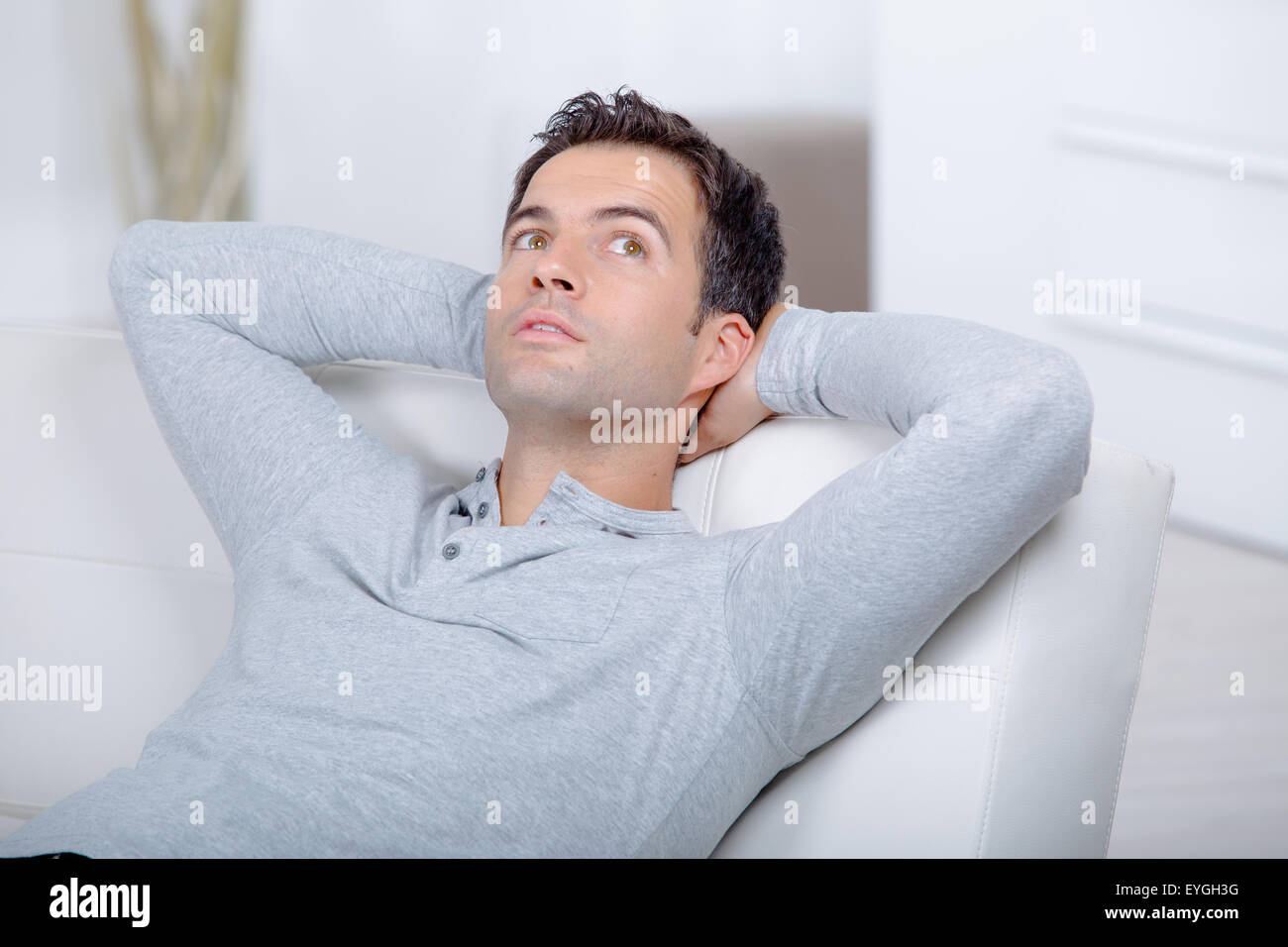 Man relaxing on his sofa Stock Photo - Alamy