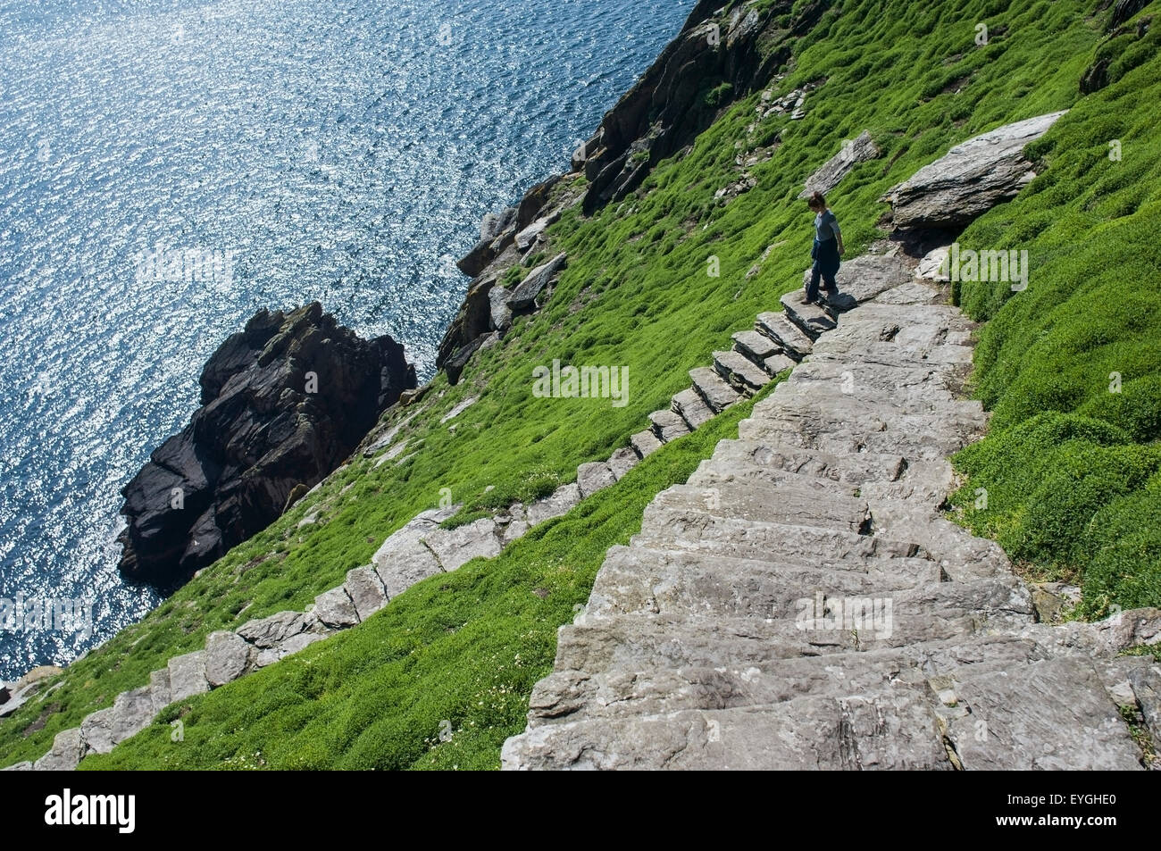 Hiker on footpath climbing up Skellig Michael; Skellig Islands, County ...