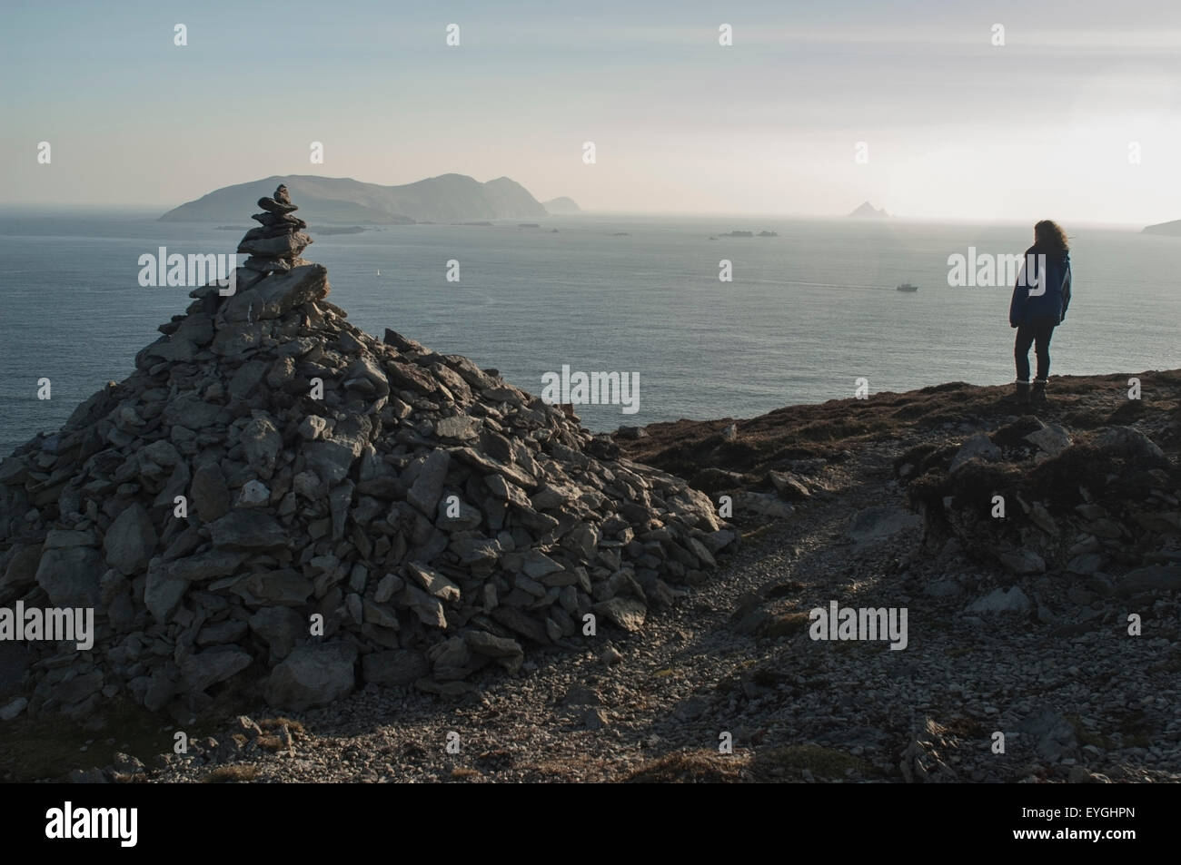 UK, Ireland, County Kerry, Dingle, Woman looking out to Blasket Islands ...