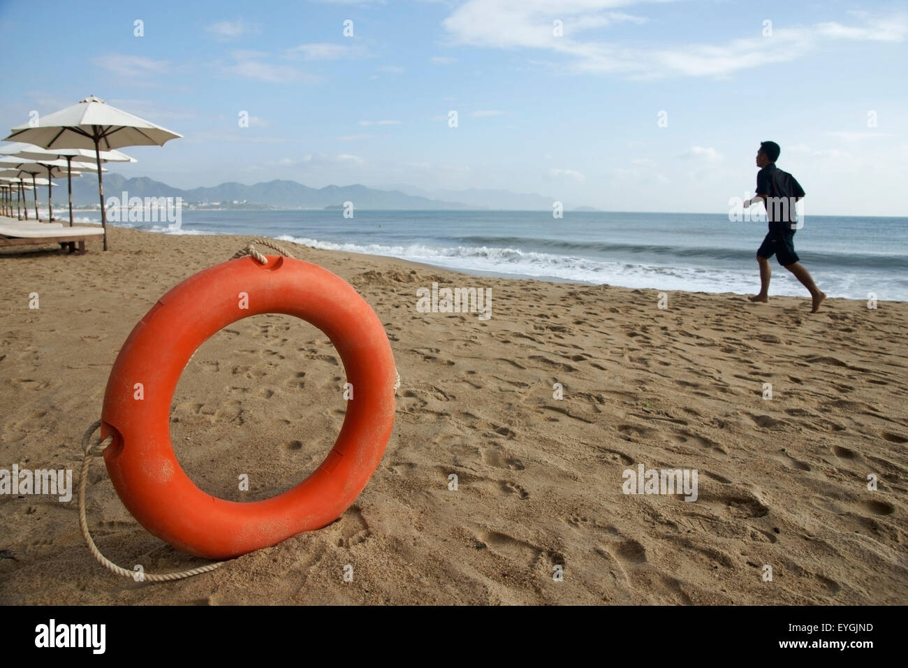Vietnam, Life Preserver On Beach With Jogger In Background; Nha Trang ...