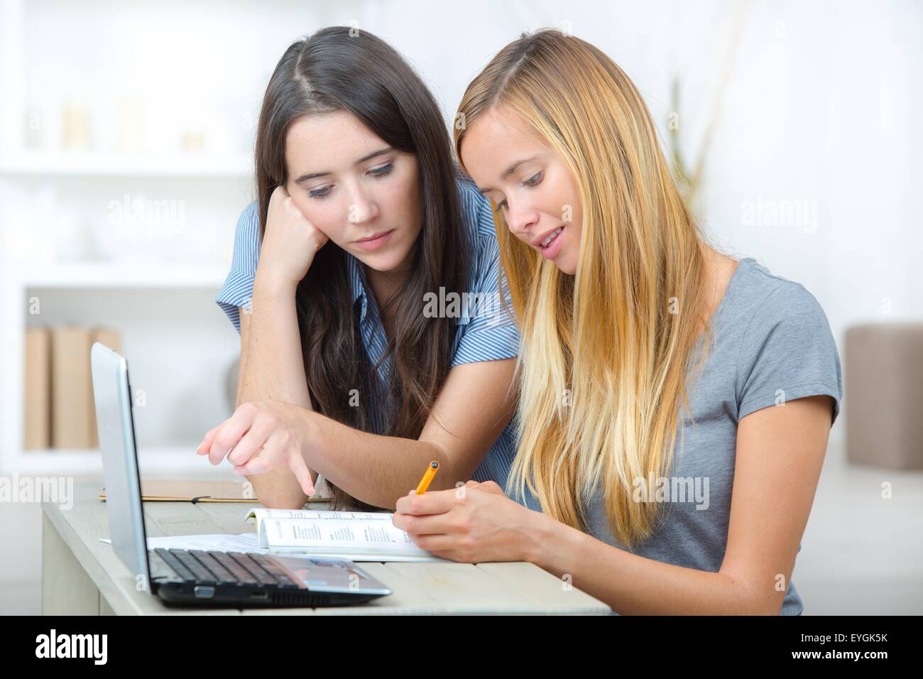 Two female students using a laptop Stock Photo - Alamy