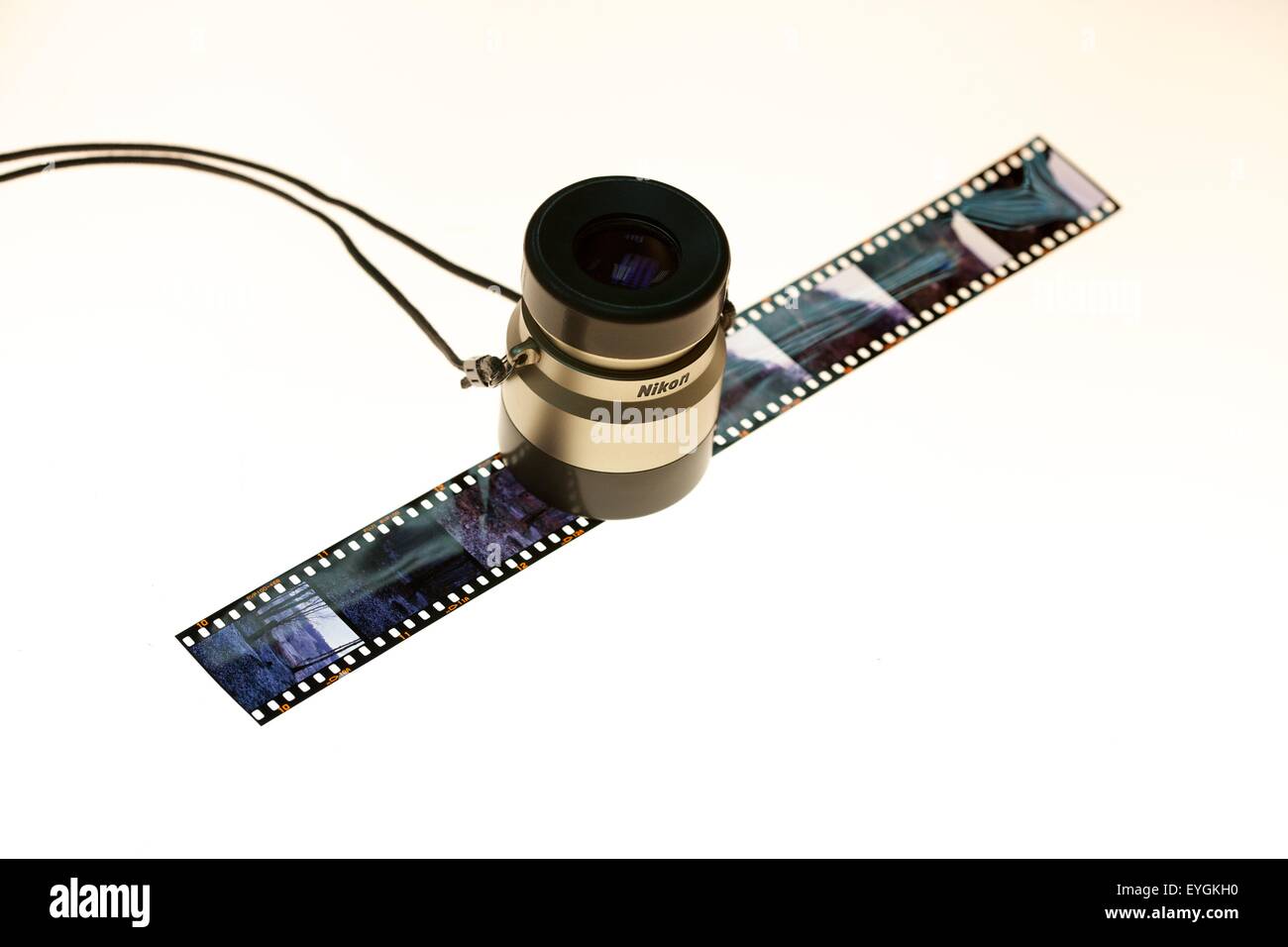 A photographers loope with Transparency film on a lightbox in a studio ...