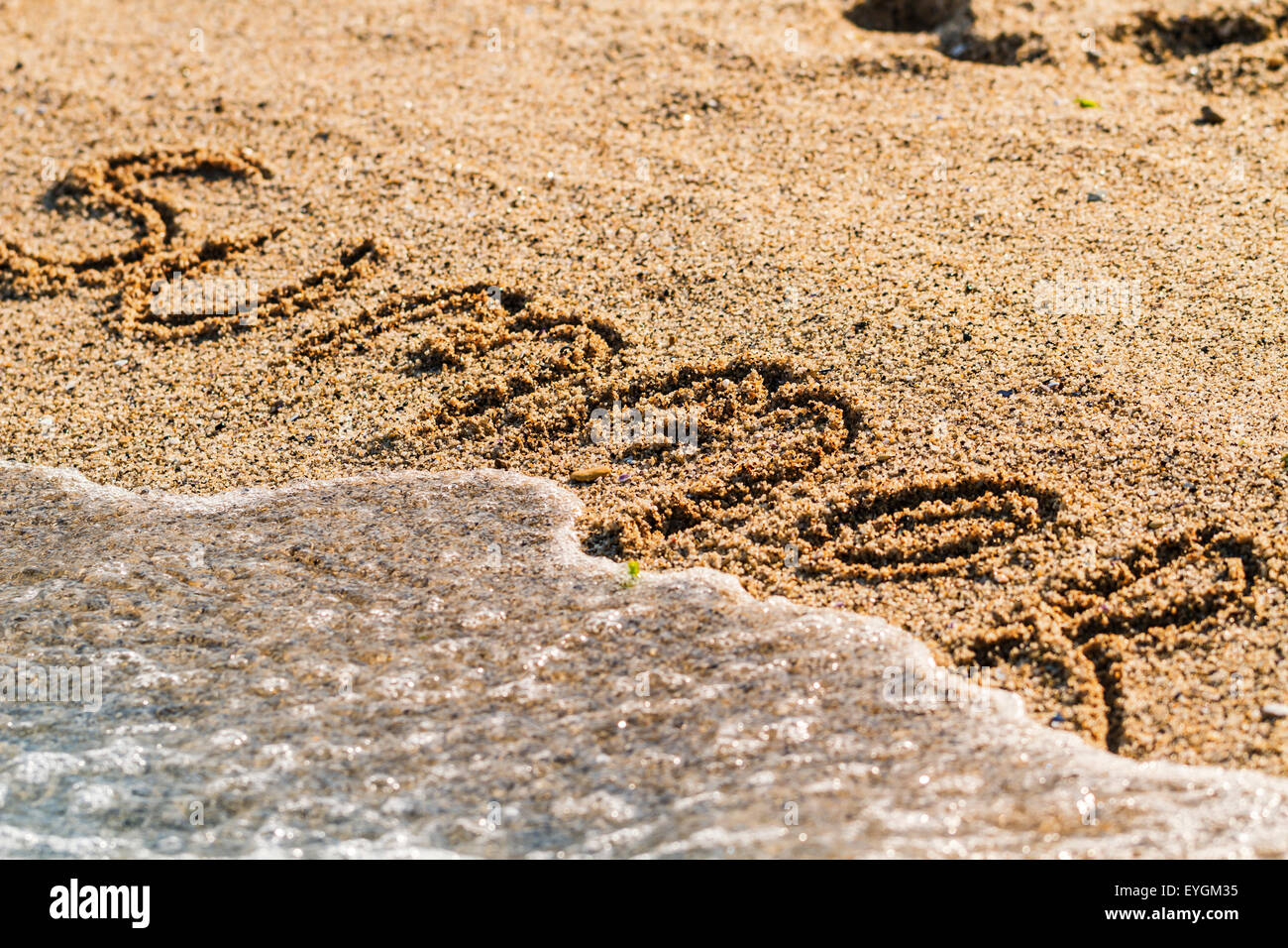 Summer sign on sand beach of resort Stock Photo - Alamy