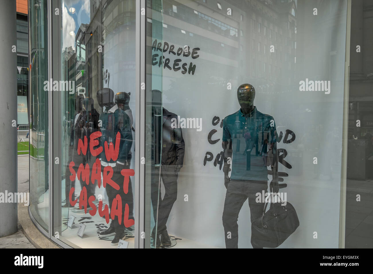 Faceless manikins in a modern fashion shop window modeling modern ...