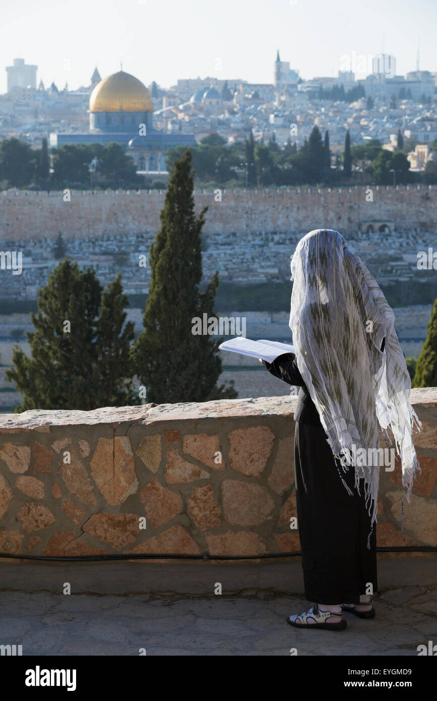 Israel, Pilgrim praying on Mount of Olives facing Old City; Jerusalem ...
