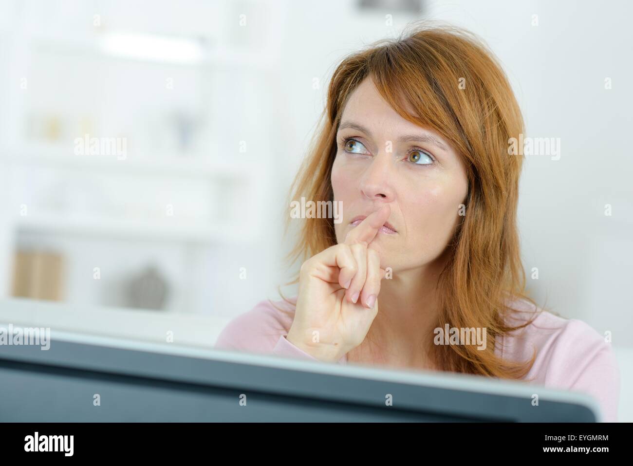 Stressed woman looking at her computer screen Stock Photo - Alamy