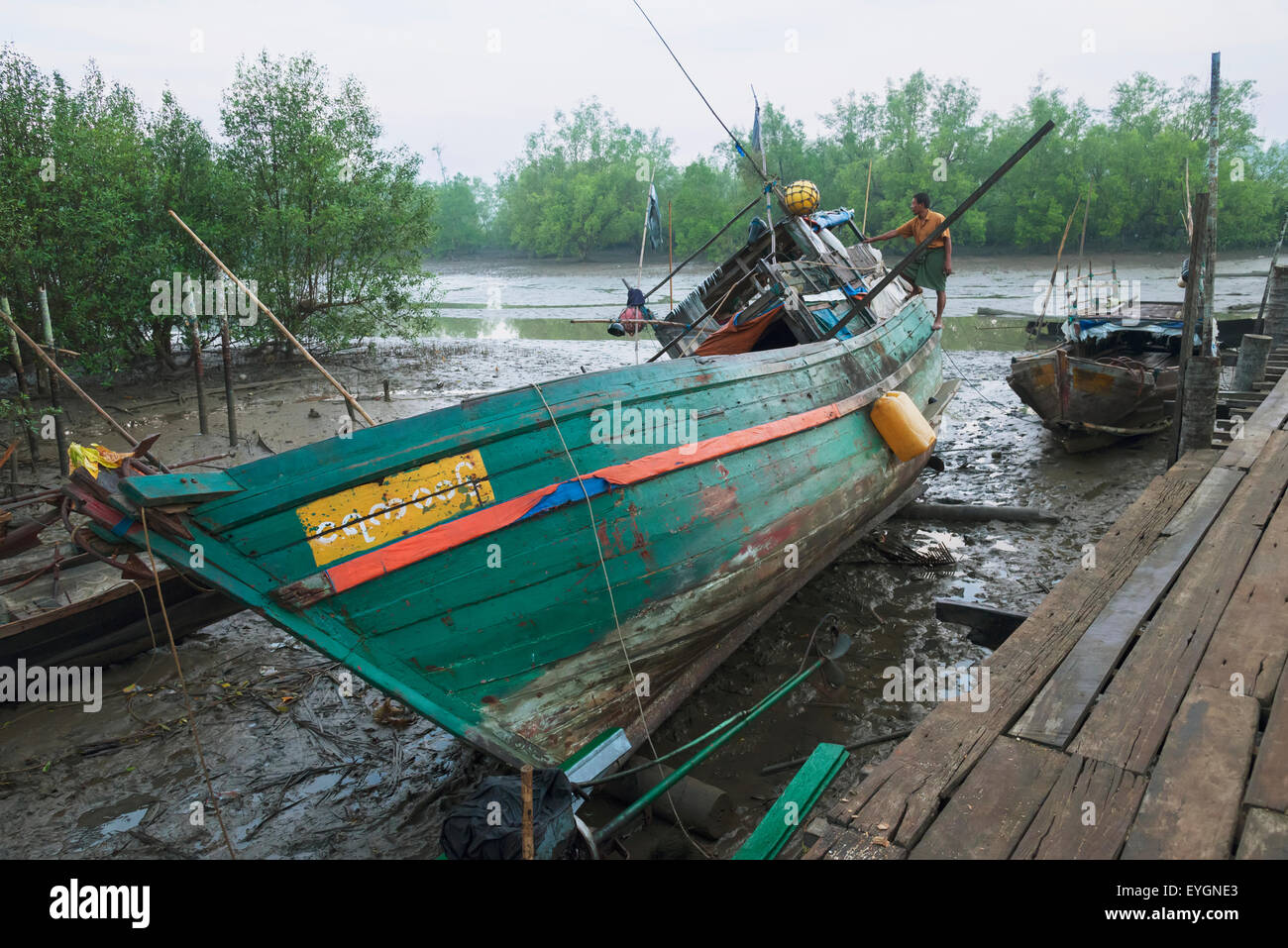 Myanmar (Burma), Irrawaddyi division, Wooden fishing boat at low tide ...