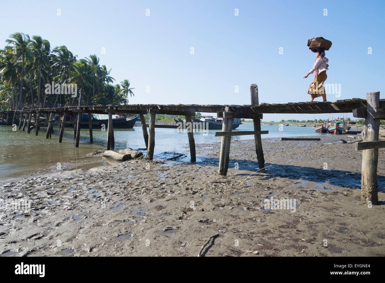 Myanmar (Burma), Woman with load on her head crossing wooden bridge ...