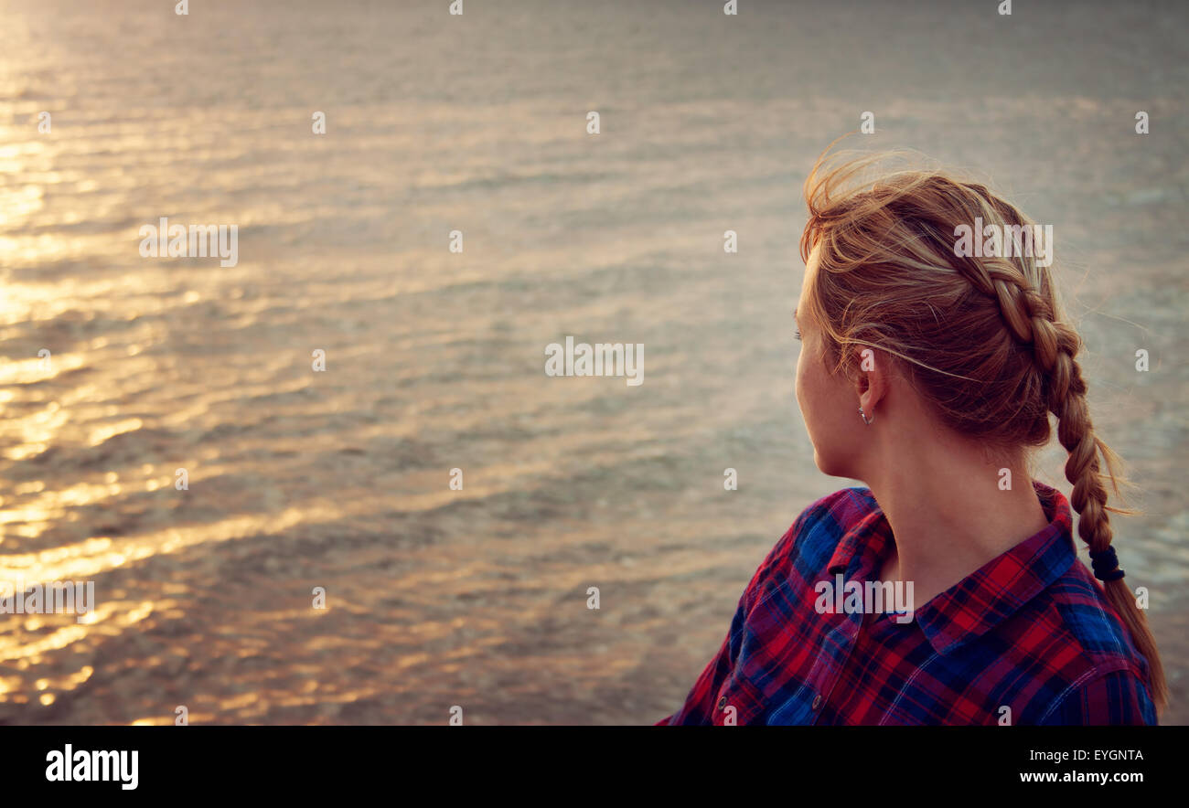 young woman looking at sunset Stock Photo - Alamy