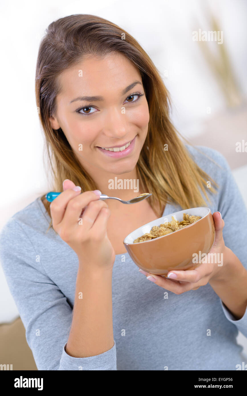 Woman eating cereal for breakfast Stock Photo - Alamy