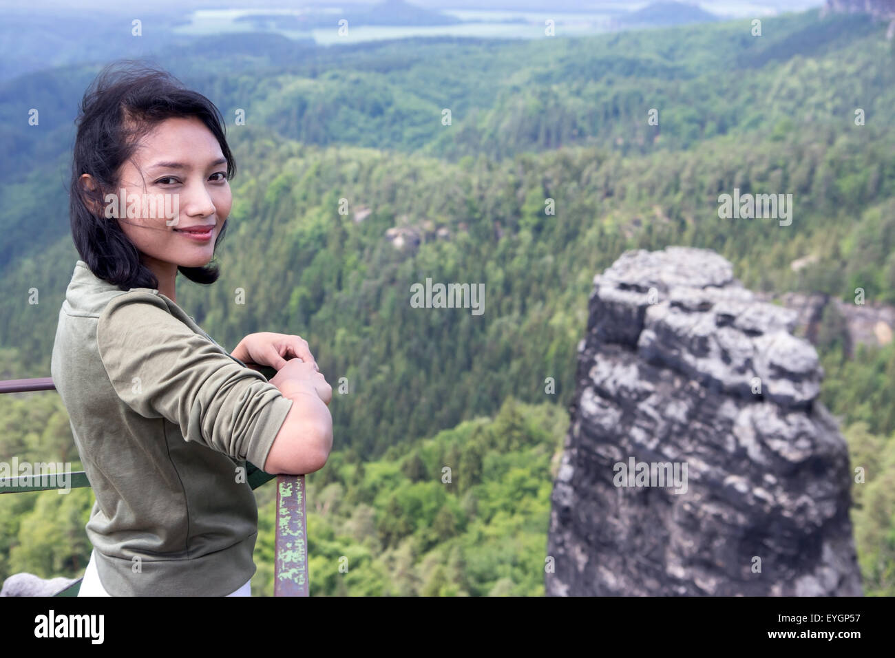 Woman on the lookout in nature Stock Photo - Alamy