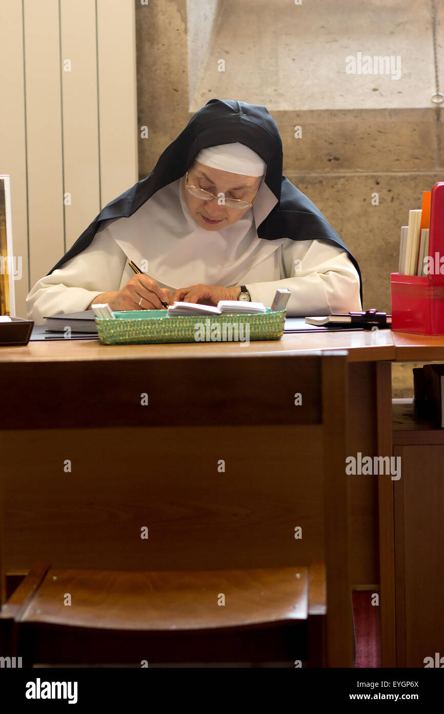 nun working at a desk in an office at church Stock Photo - Alamy