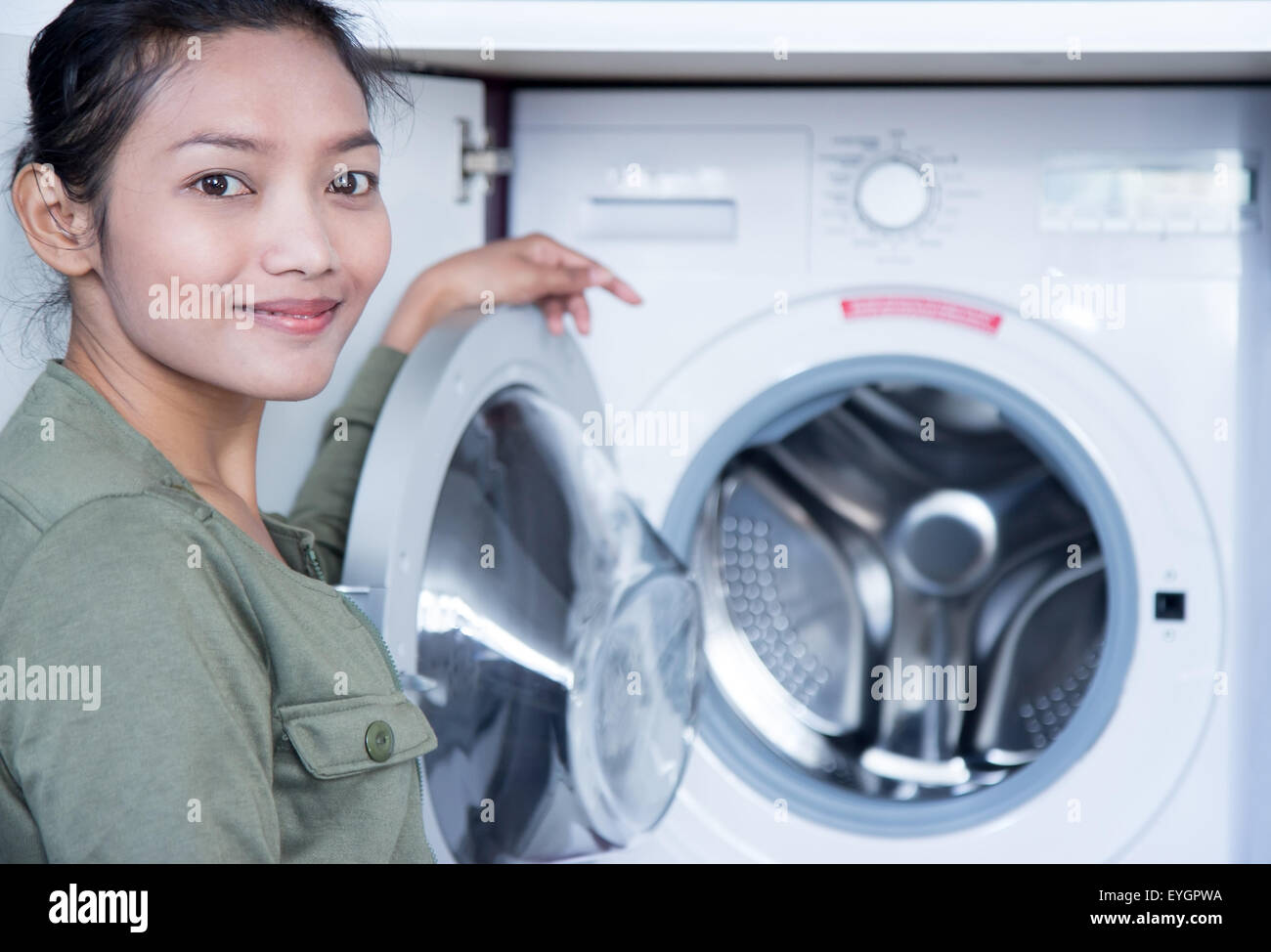 young woman opens washing machine Stock Photo - Alamy