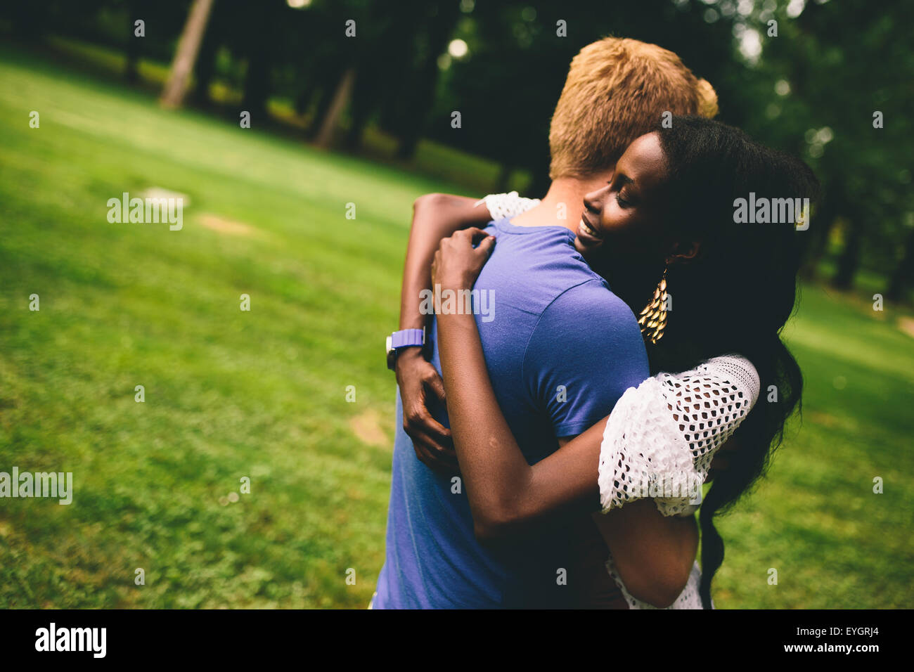 Multiracial couple in the park Stock Photo - Alamy