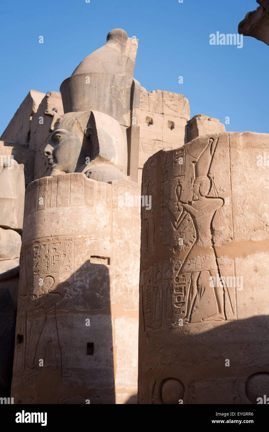 Hieroglyphics and Colossus in the setting sun at Luxor temple, Egypt ...