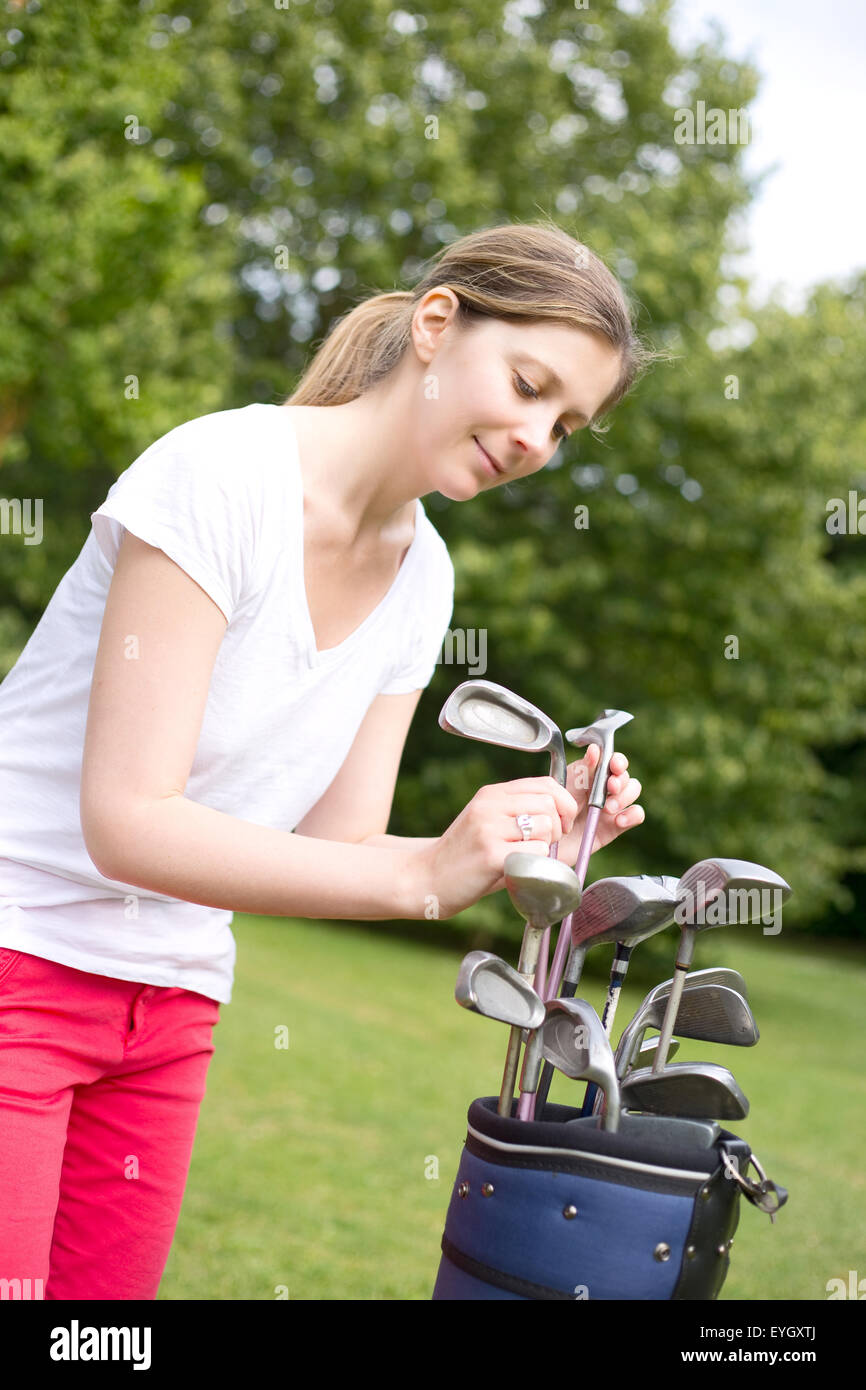 young woman playing golf Stock Photo - Alamy