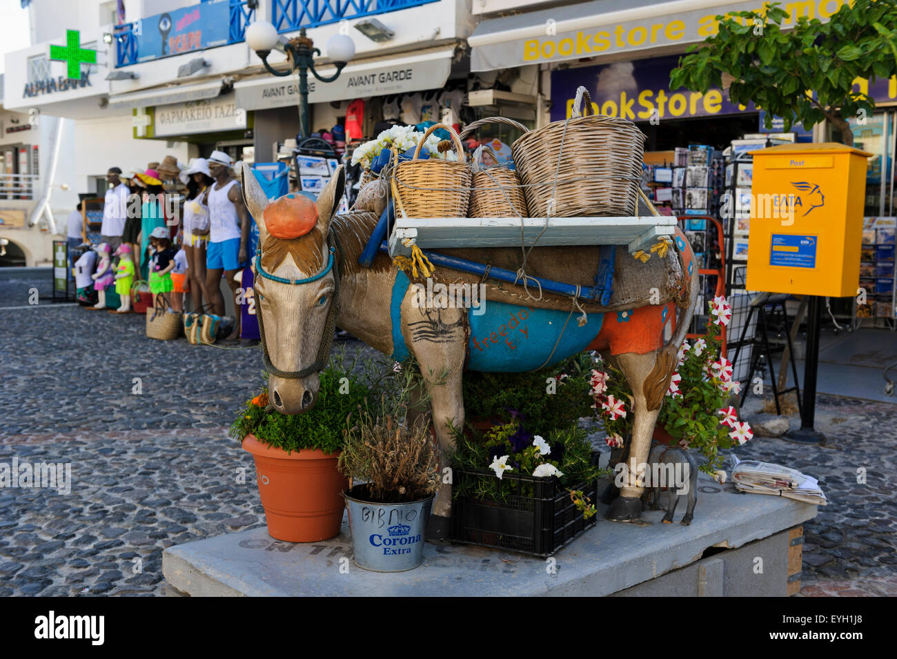 A decorative donkey in a square outside a row of shops in Fira ...