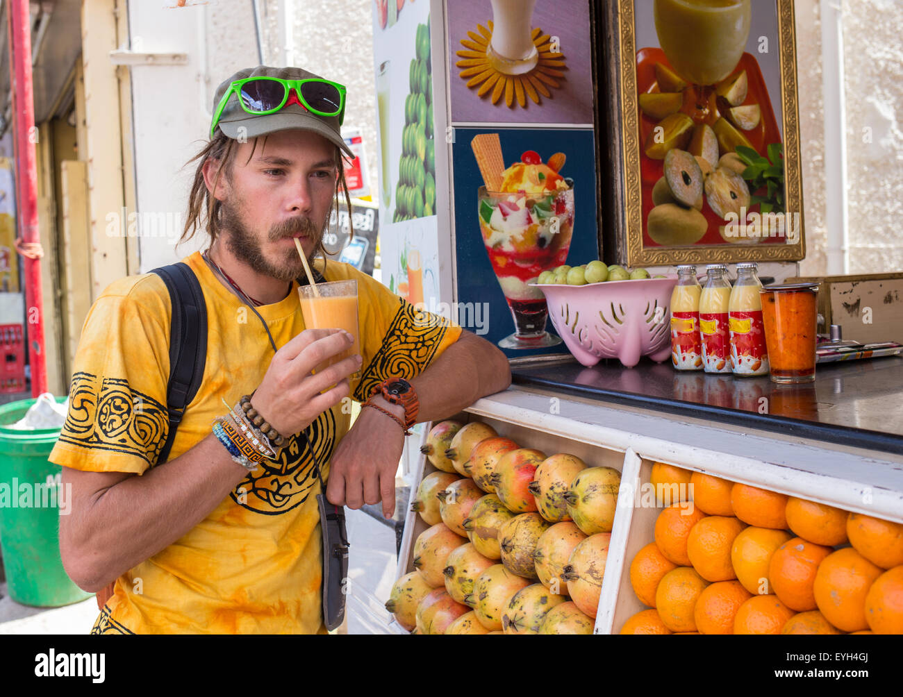 Portrait of a young man who is drinking juice Stock Photo - Alamy