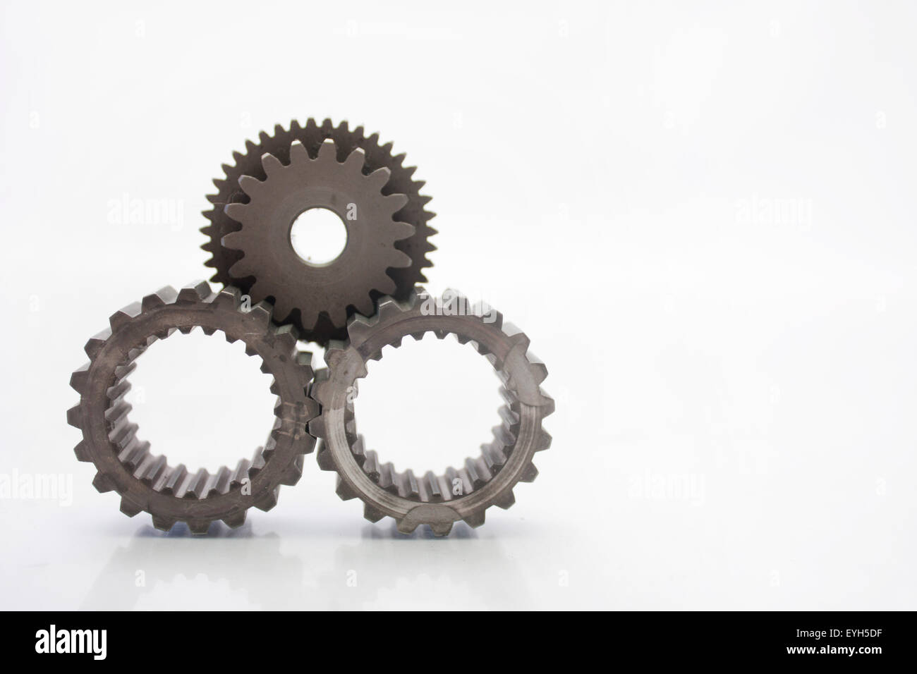 A stack of three gears on a white background Stock Photo - Alamy