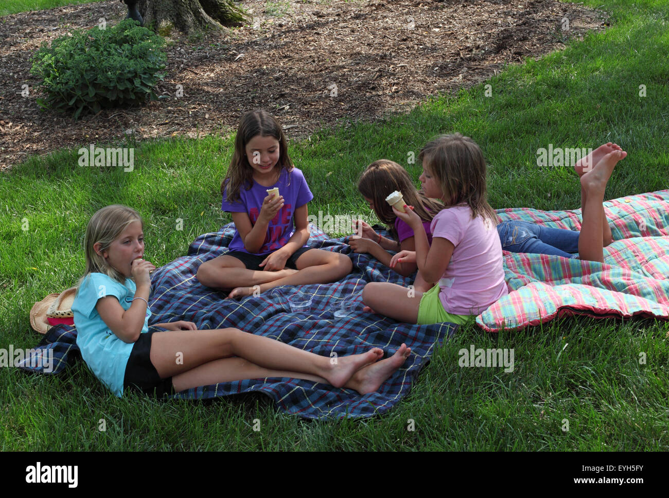 4 girls relaxing and having ice cream outdoors Stock Photo - Alamy