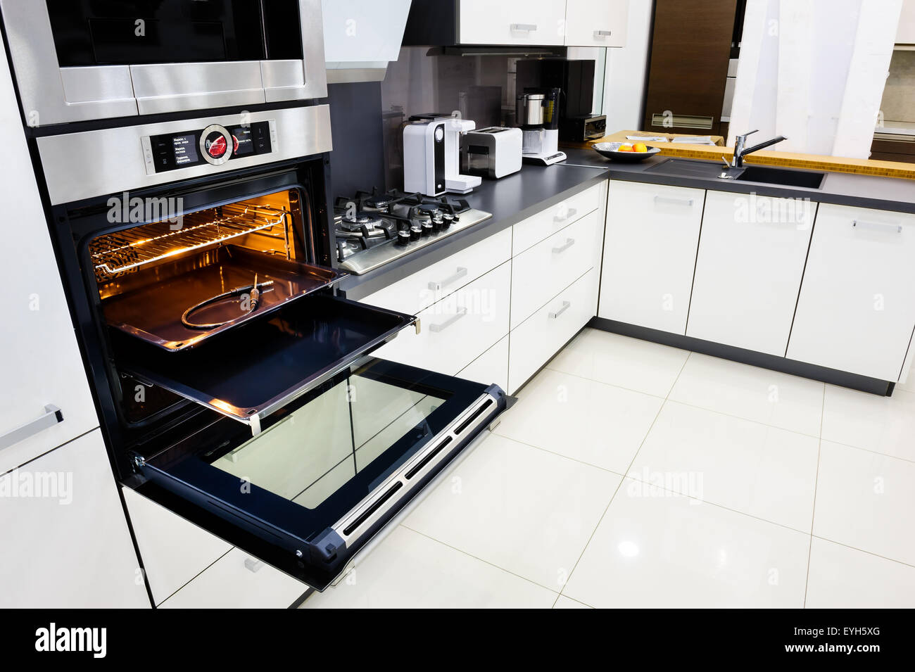 Modern hi-tek kitchen, oven with open door Stock Photo - Alamy