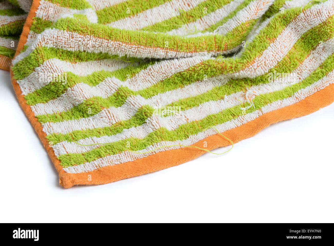 A close up of a colorful towel with loose, frayed threads on a white ...